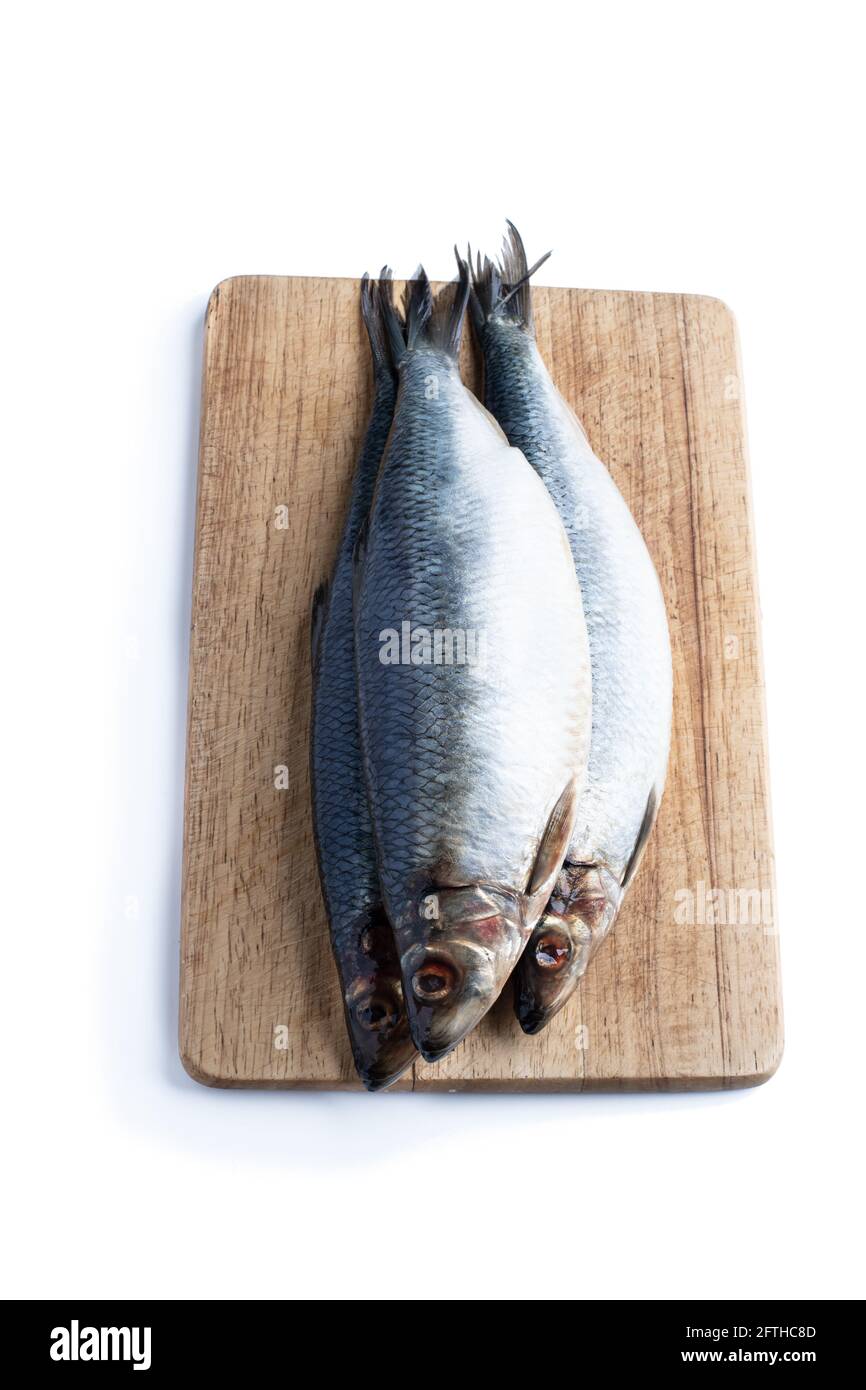 Raw herring fresh fish on wooden board isolated on white Stock Photo ...