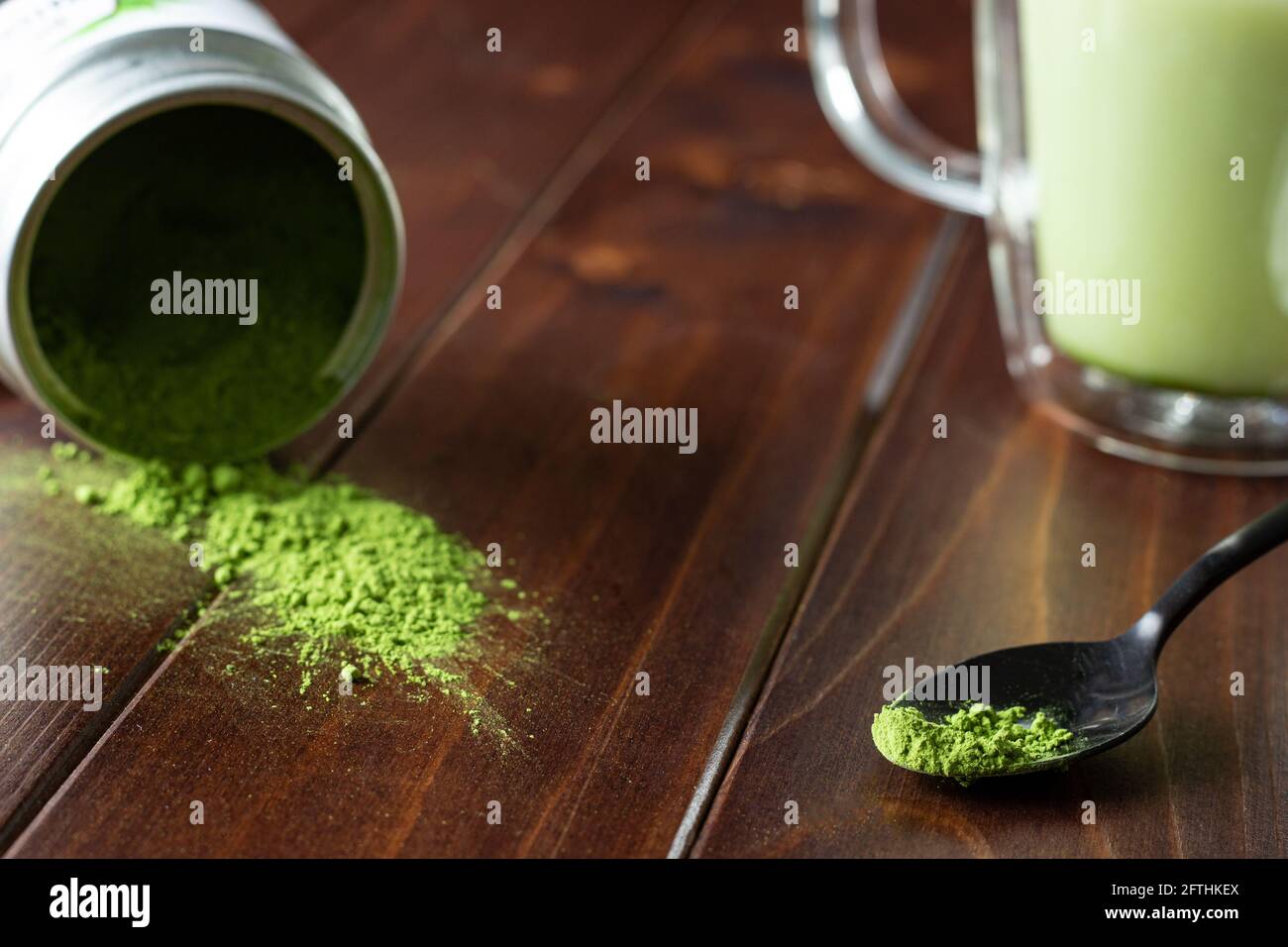 Matcha drink and powder on dark wood; Japanese green tea; serving ...