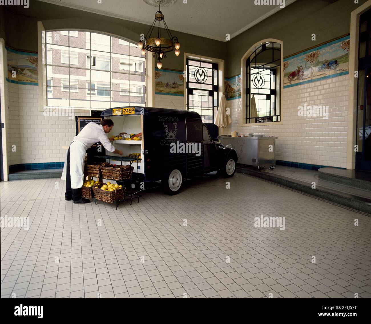 Man loading van in garage of thirties restaurant Bibendum Stock Photo ...