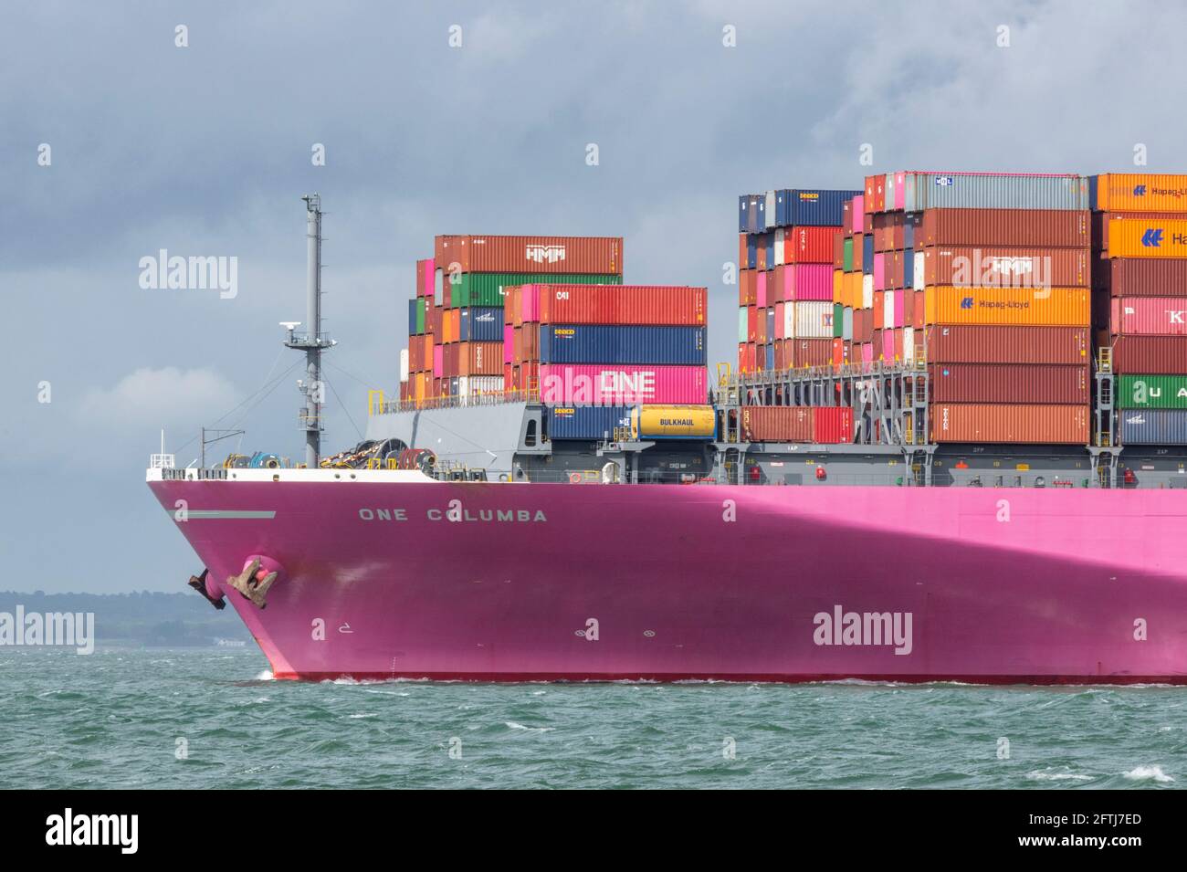 the bows of a large pink coloured container ship entering the port of ...