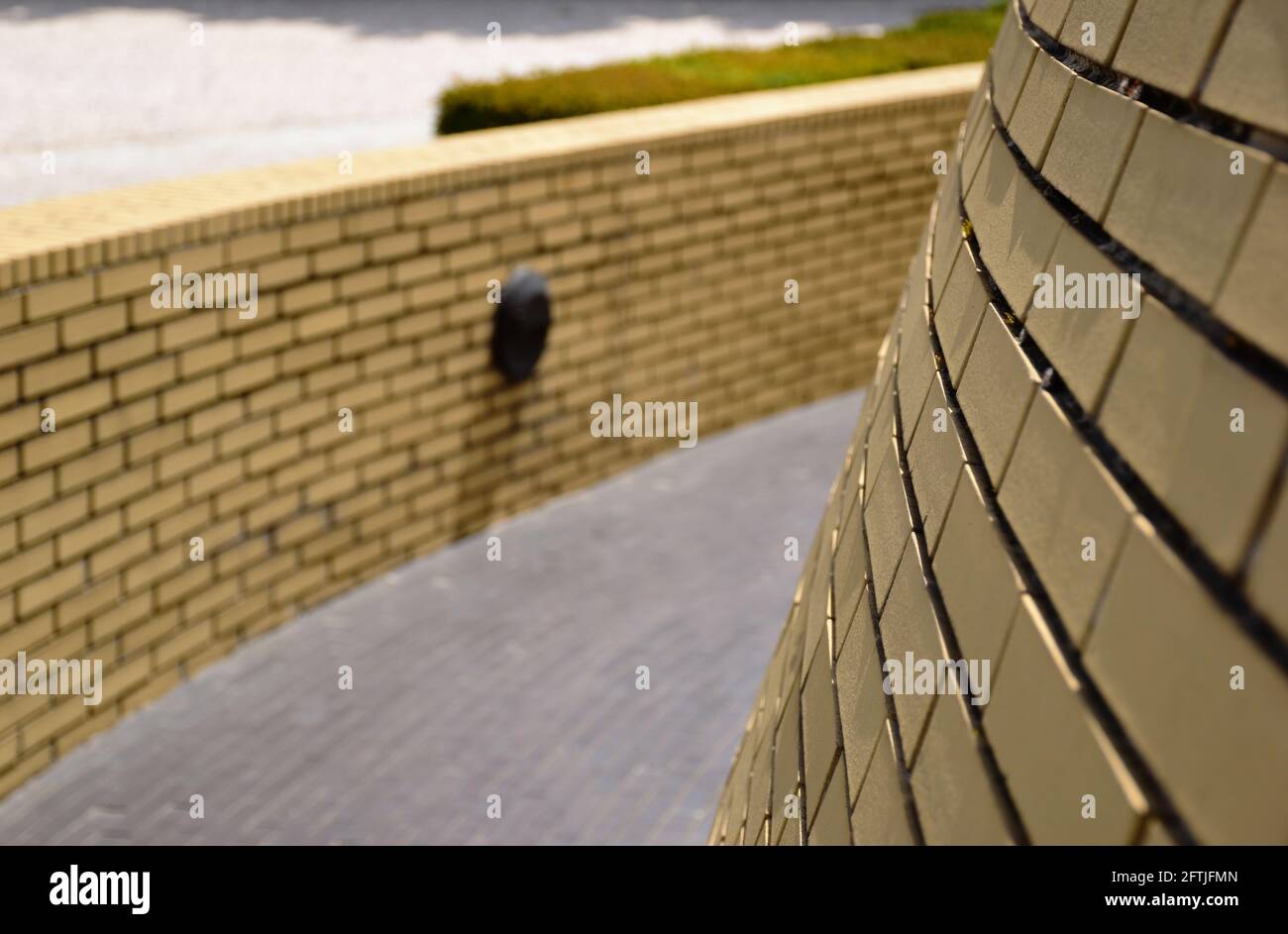 yellow brick structure close up with spiraling black brick ramp ...