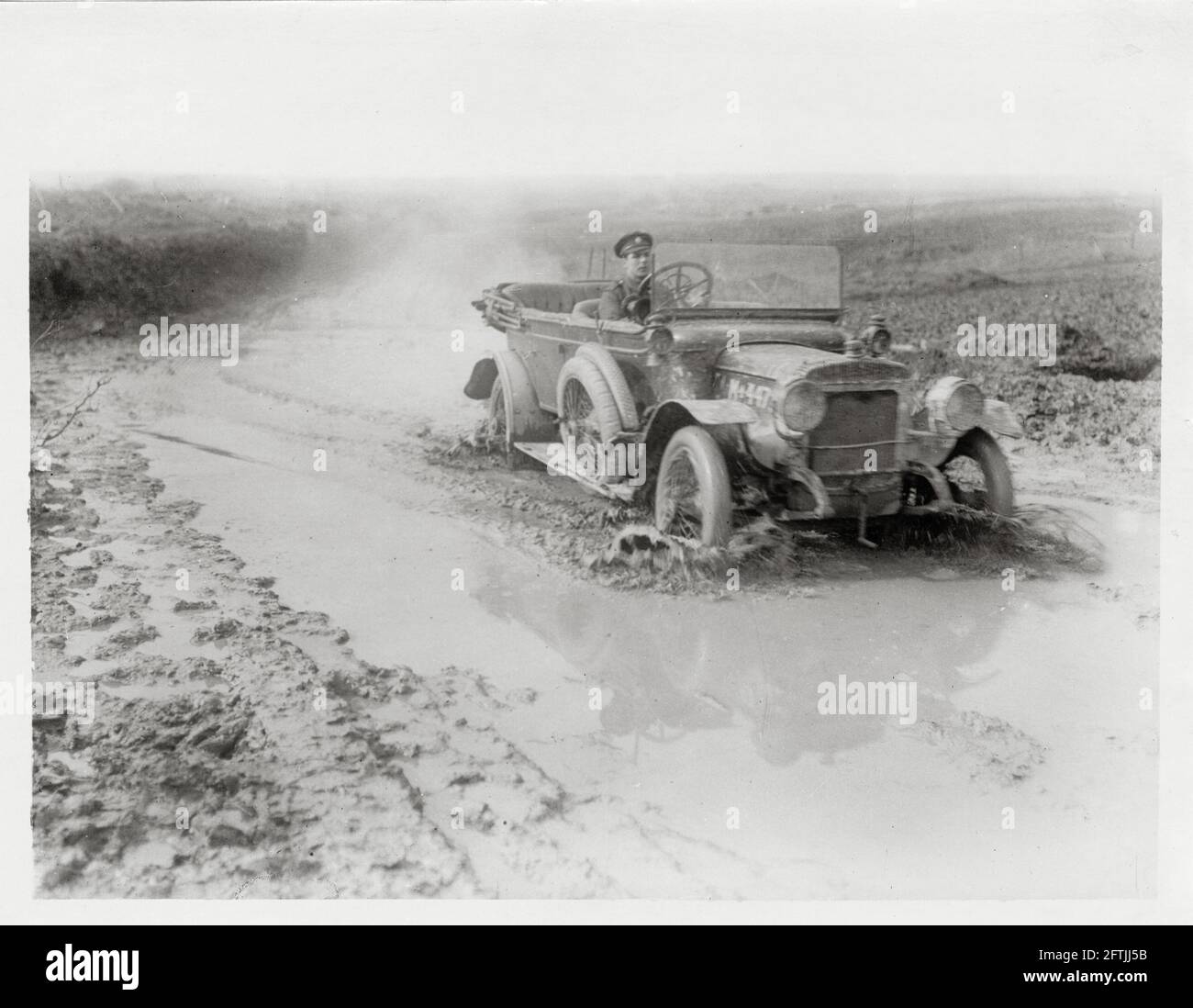 World War One, WWI, Western Front - A car goes through a flood on a bad ...