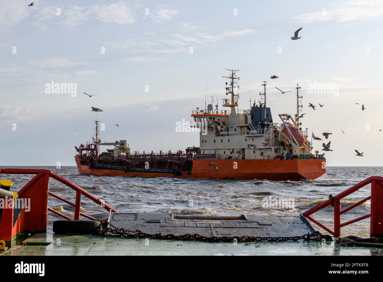 Hopper dredger at sea. Vessel engaged in dredging. Construction Marine ...