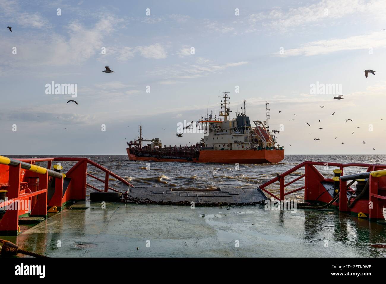 Hopper dredger at sea. Vessel engaged in dredging. Construction Marine ...
