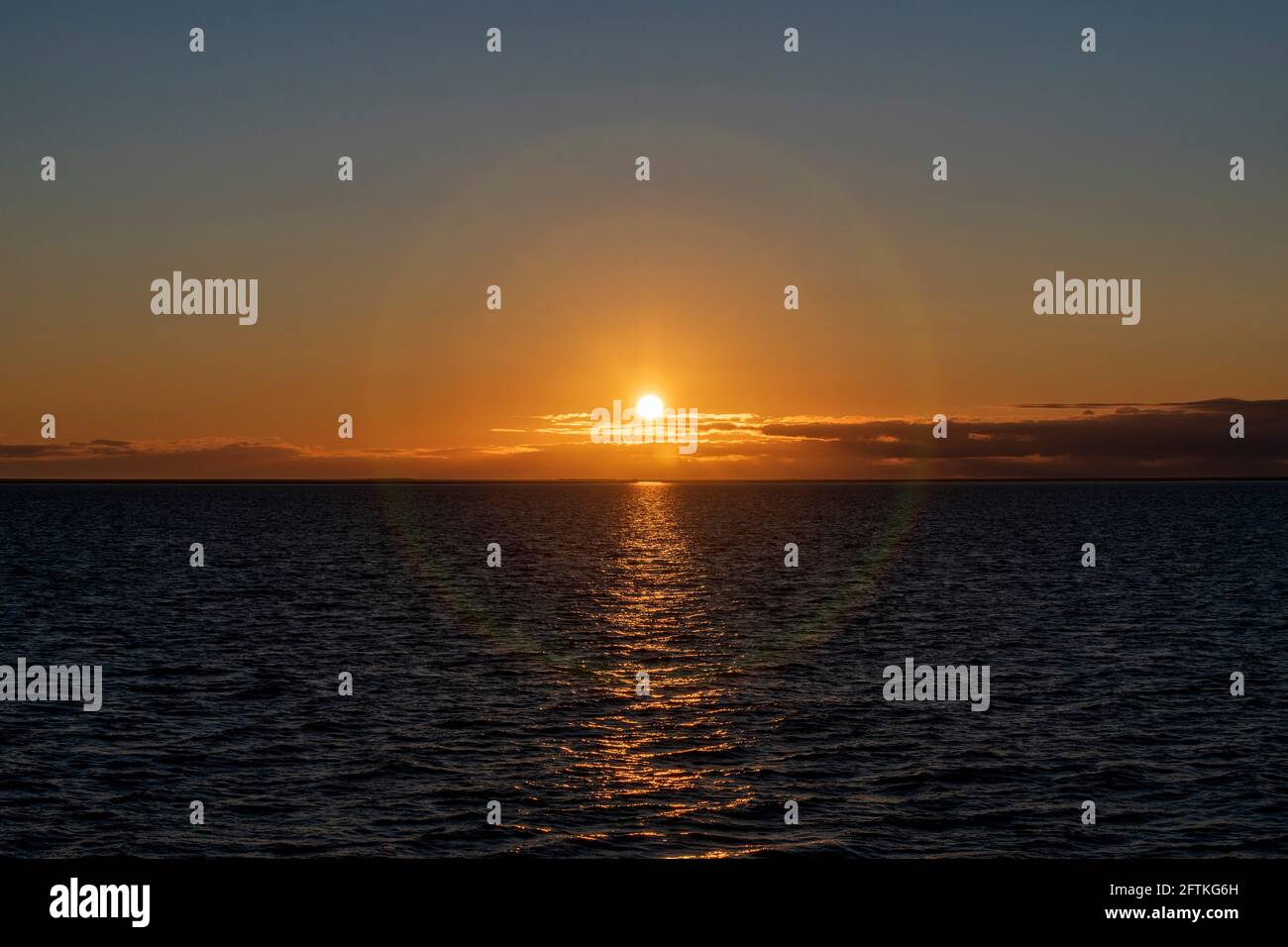 Beautiful sunset on sky with clouds at sea. Golden hour lighting Stock ...