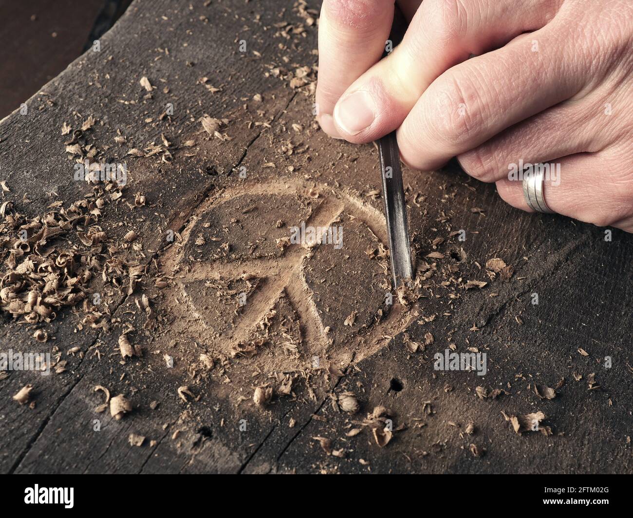 The peace symbol carved in wood with chisels. Peace concept, global ...
