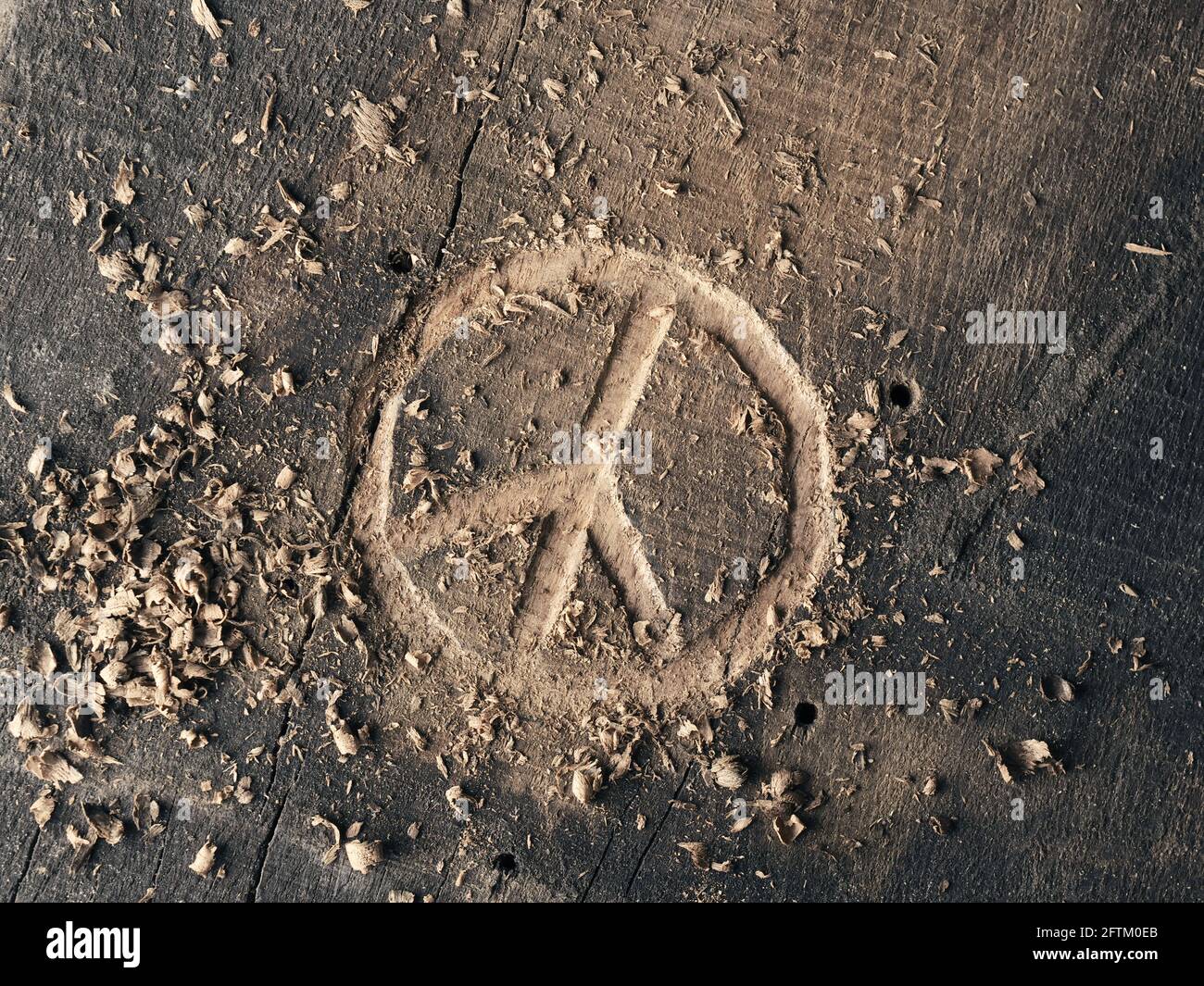 The peace symbol carved in wood with chisels. Peace concept, global ...