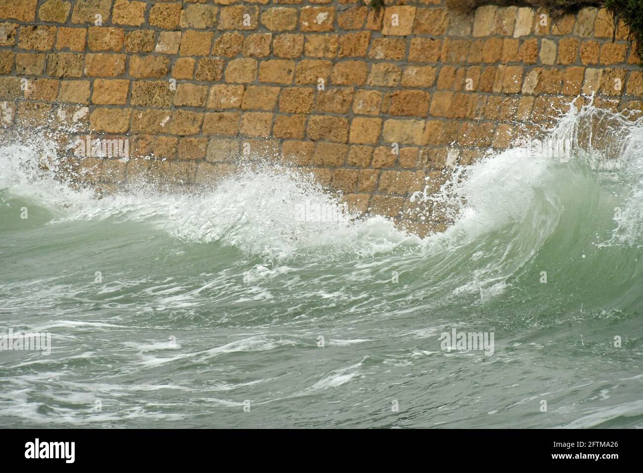 wave break on stone wall Stock Photo - Alamy