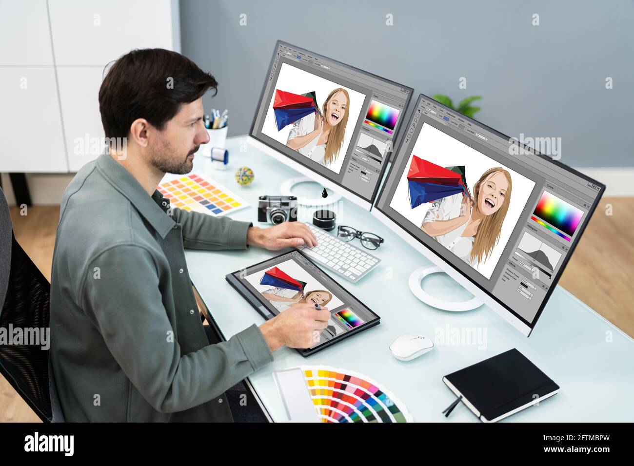 Designer And Photographer Using Multiple Computer Screens Stock Photo ...