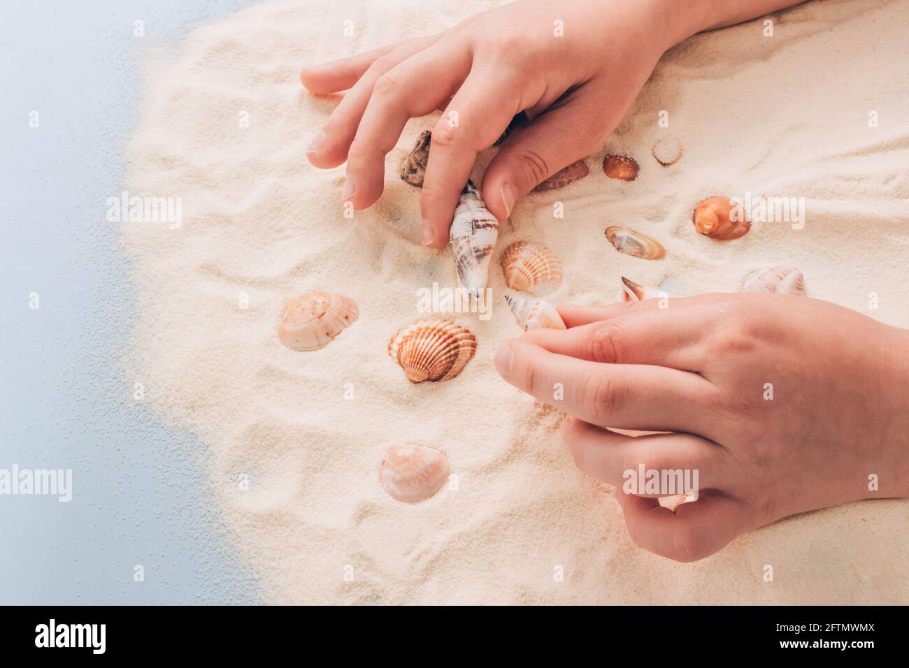 Boy playing with sea shells and sand - Montessori education concept ...