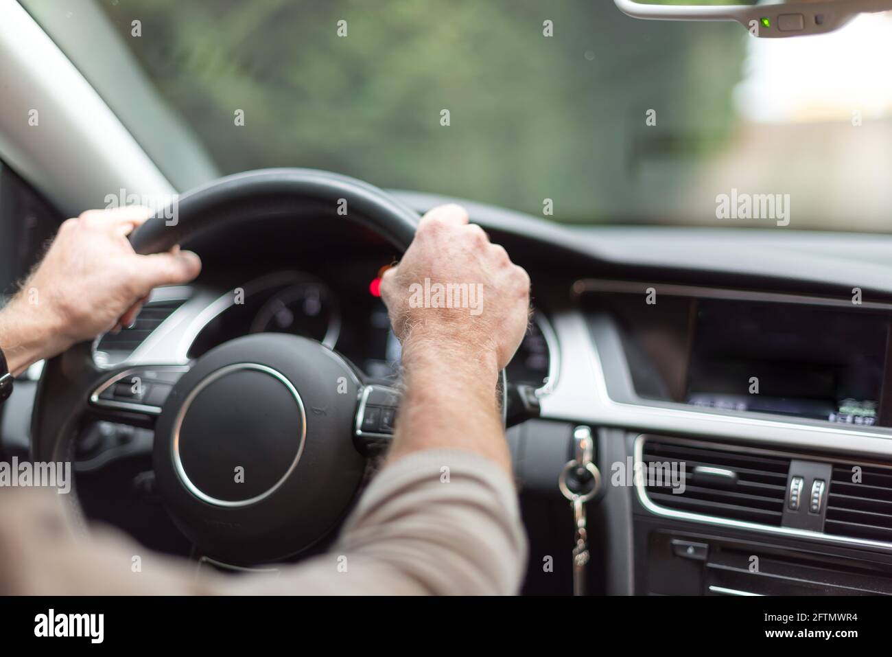 Car driving with both hands on the wheel Stock Photo - Alamy