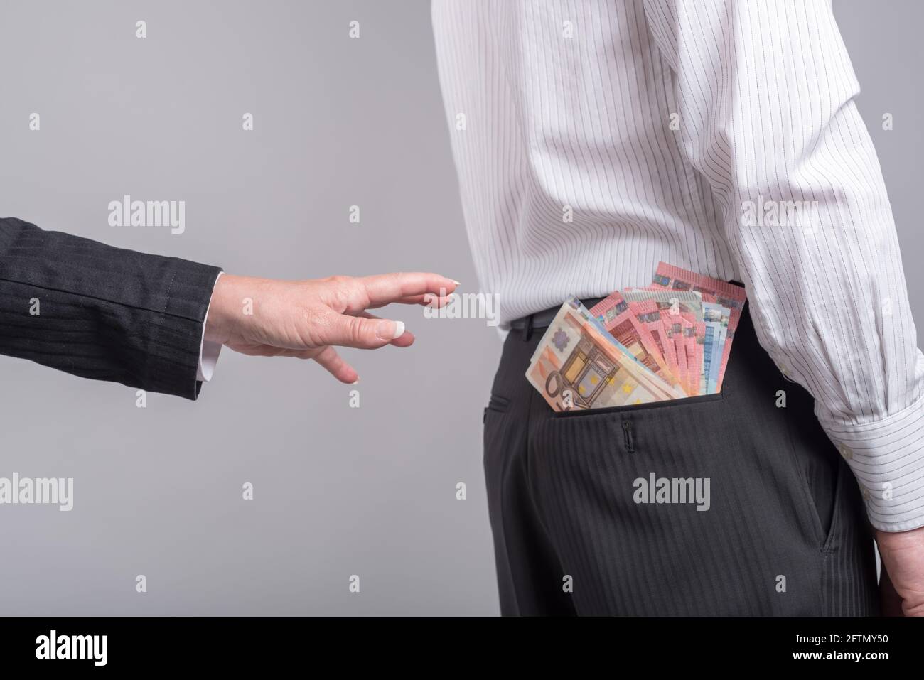 Woman about to take money out of back pocket of a businessman Stock ...