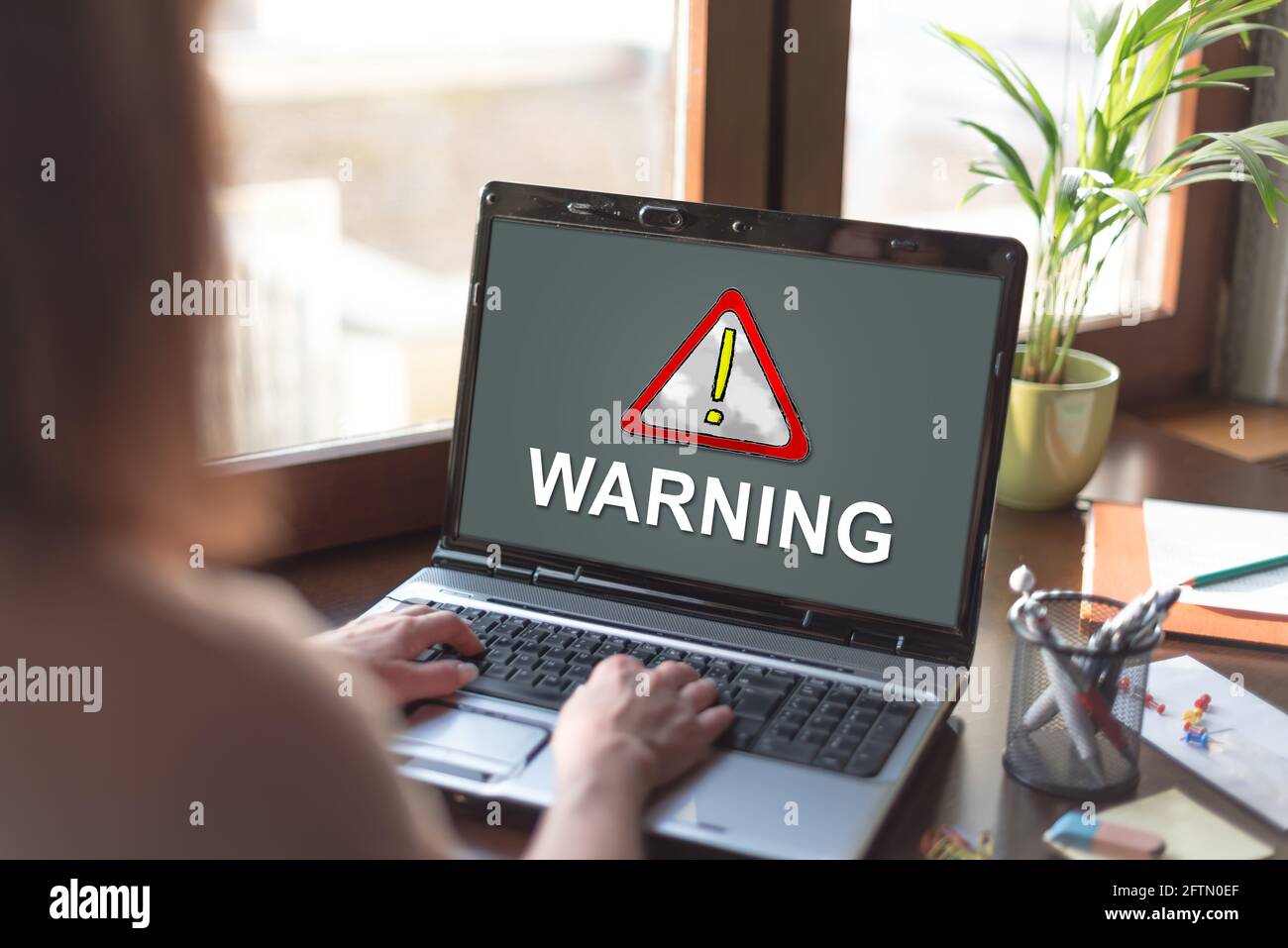 Laptop screen displaying a warning concept Stock Photo - Alamy
