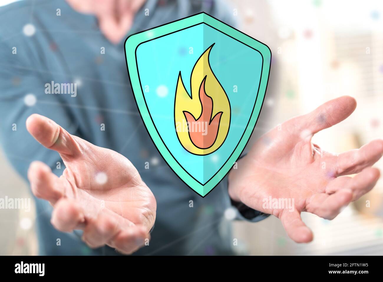 Fire protection concept above the hands of a man in background Stock ...