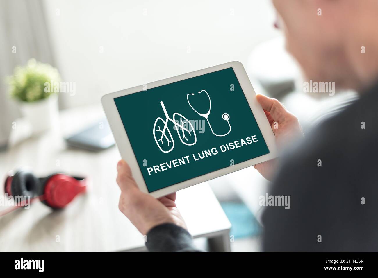 Tablet screen displaying a lung disease prevention concept Stock Photo ...