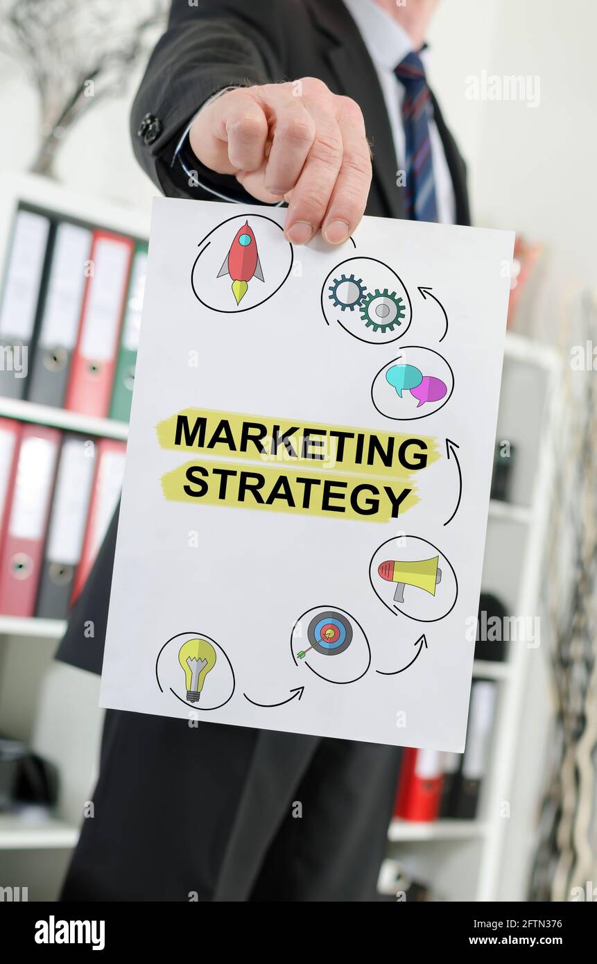 Paper showing marketing strategy concept held by a businessman Stock ...