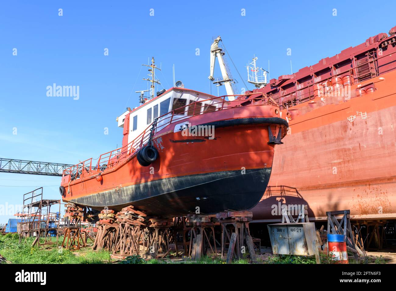 Small sized vessel ashore on ship repairing yard. Summer time Stock ...
