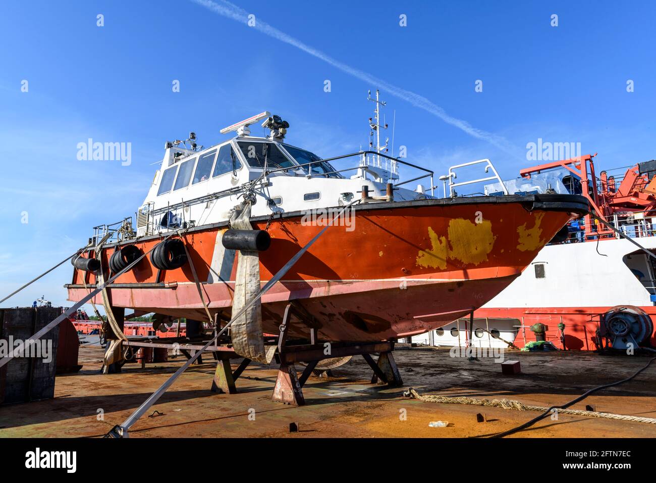 Small sized vessel ashore on ship repairing yard. Summer time Stock ...