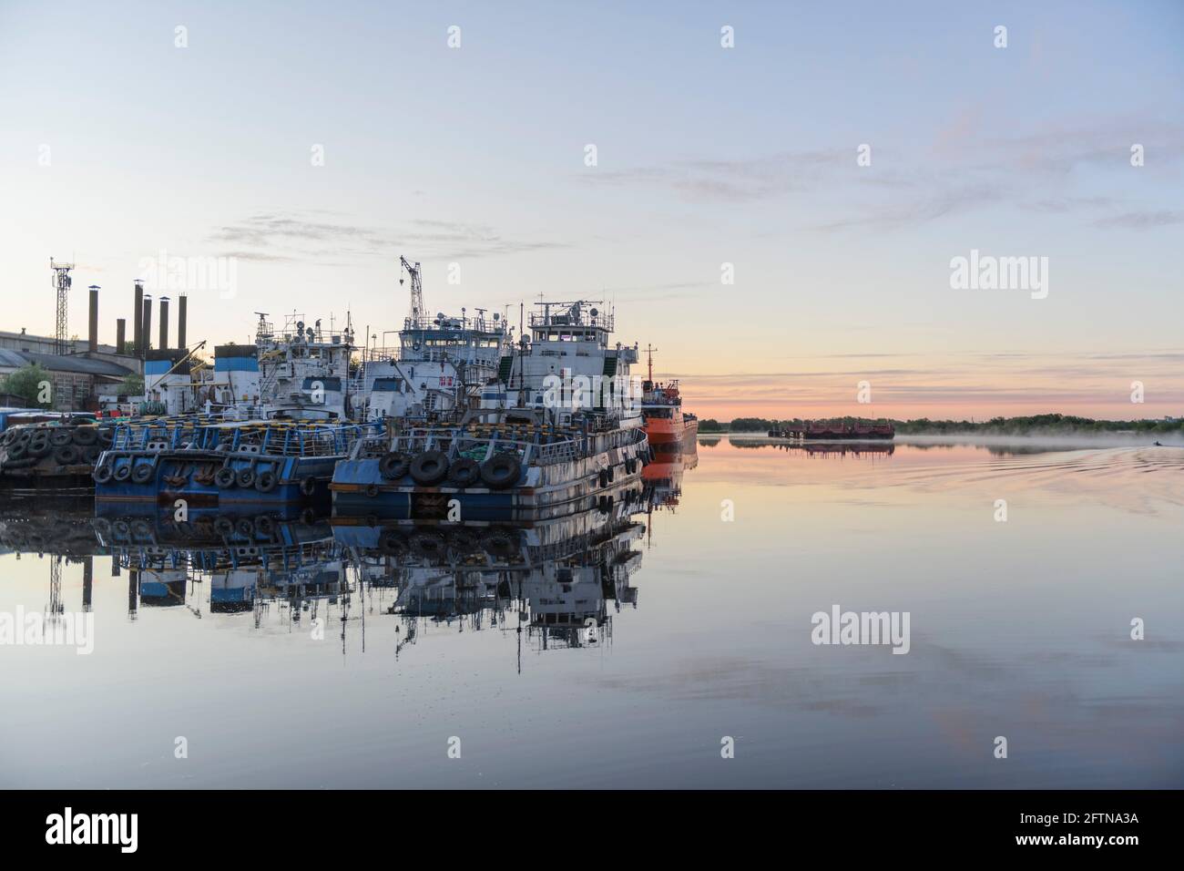 River ships moored alongside berth at summer time. Big old tugs Stock ...