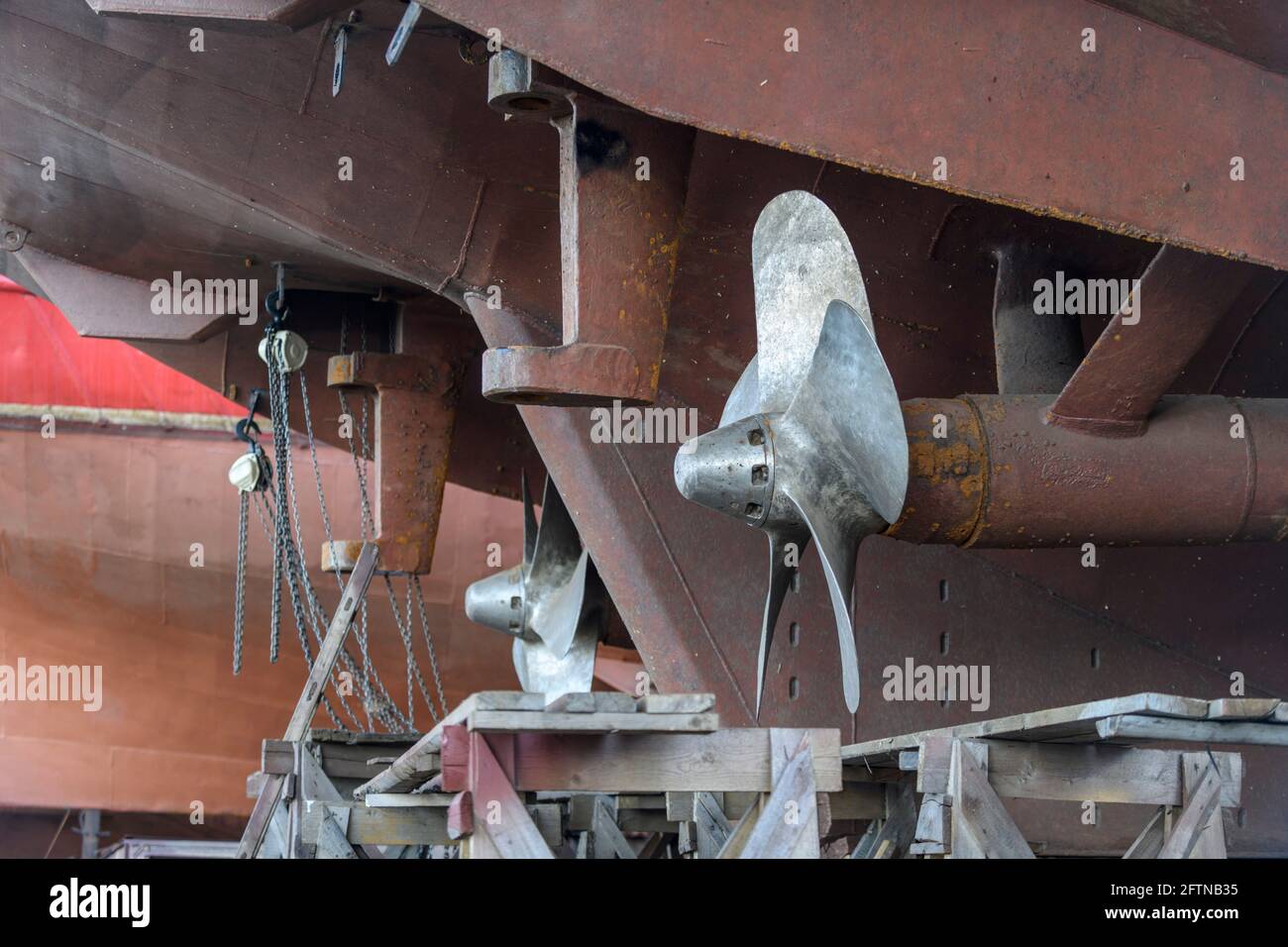 Fixed blade propeller and rudder. Cargo vessel ashore on ship repairing ...