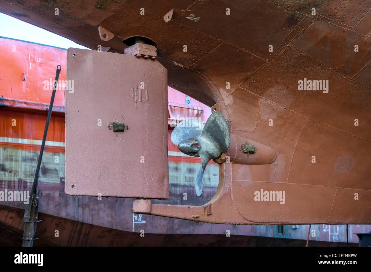 Fixed blade propeller and rudder. Cargo vessel ashore on ship repairing ...