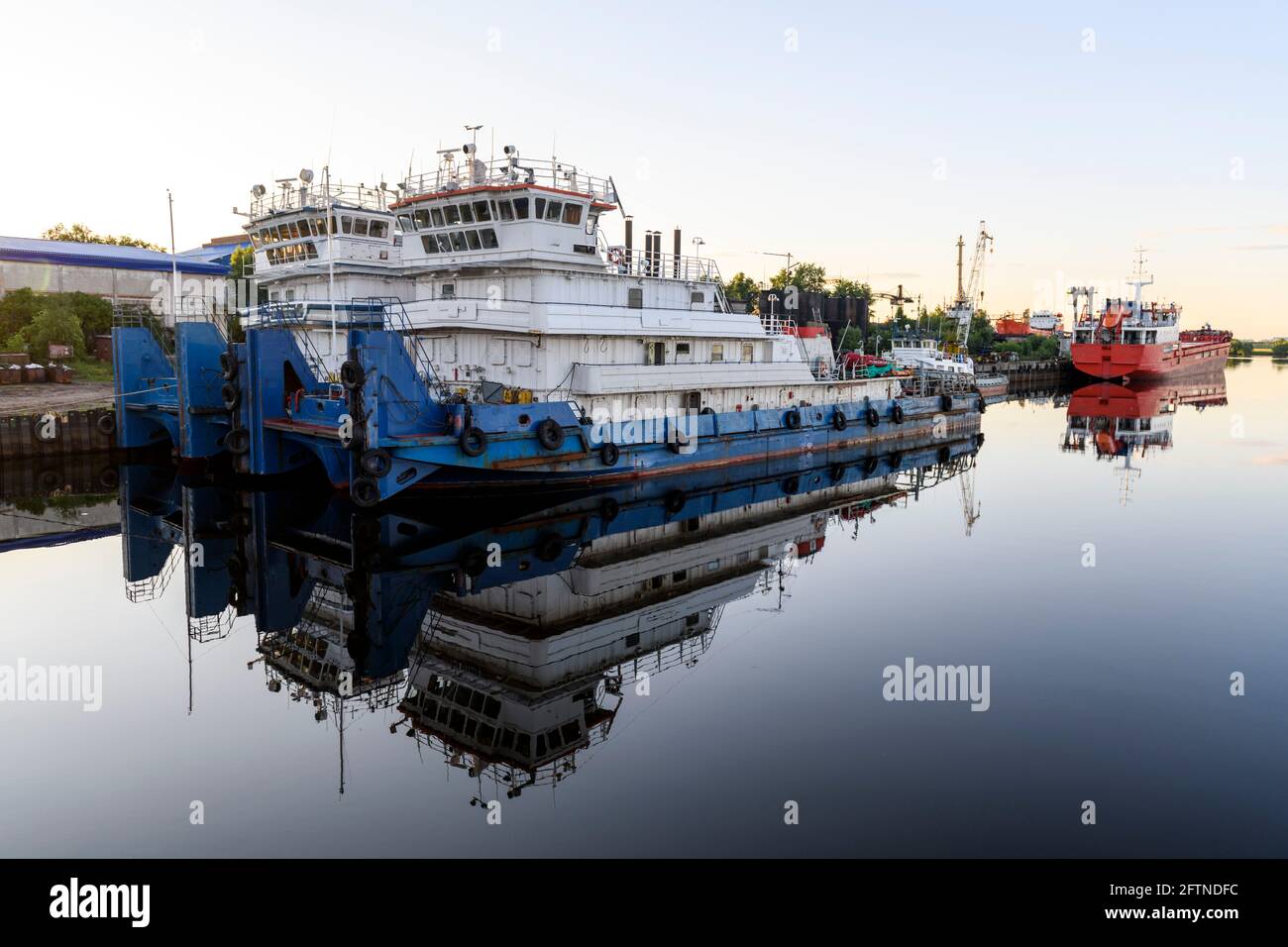 River ships moored alongside berth at summer time. Big old tugs Stock ...