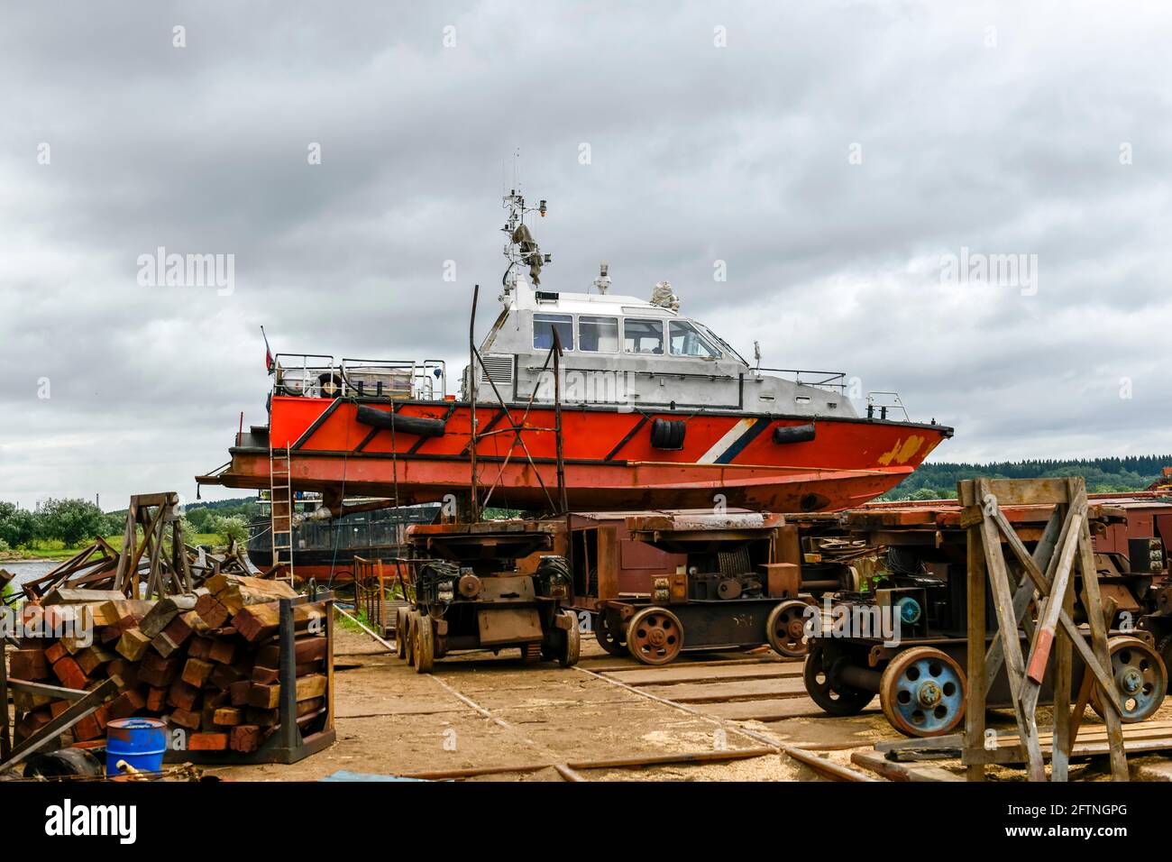 Small sized vessel ashore on ship repairing yard. Summer time Stock ...