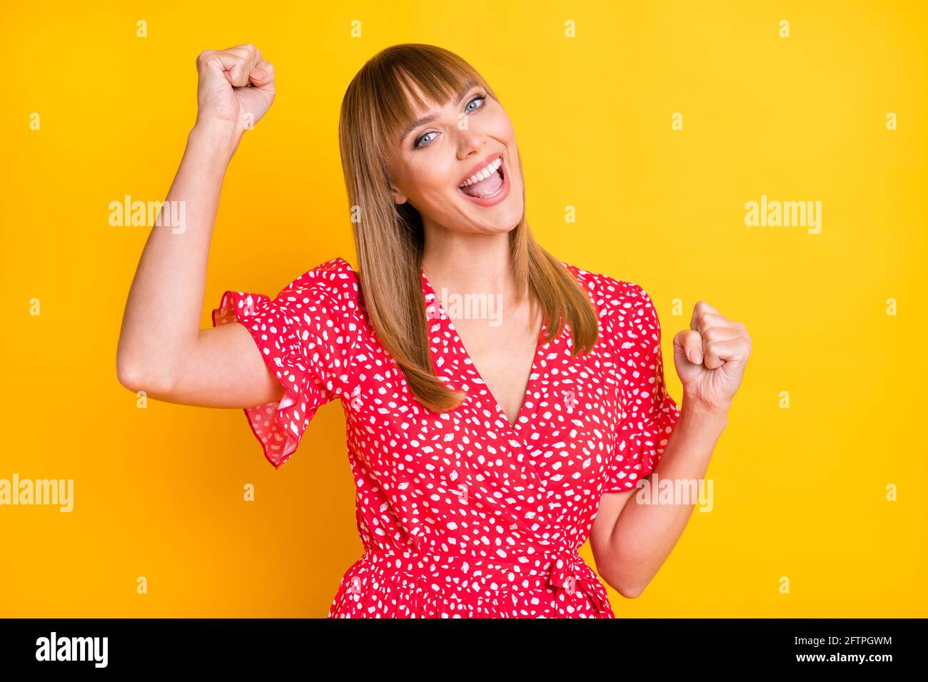 Photo of adorable lucky young lady wear red clothes rising fists ...