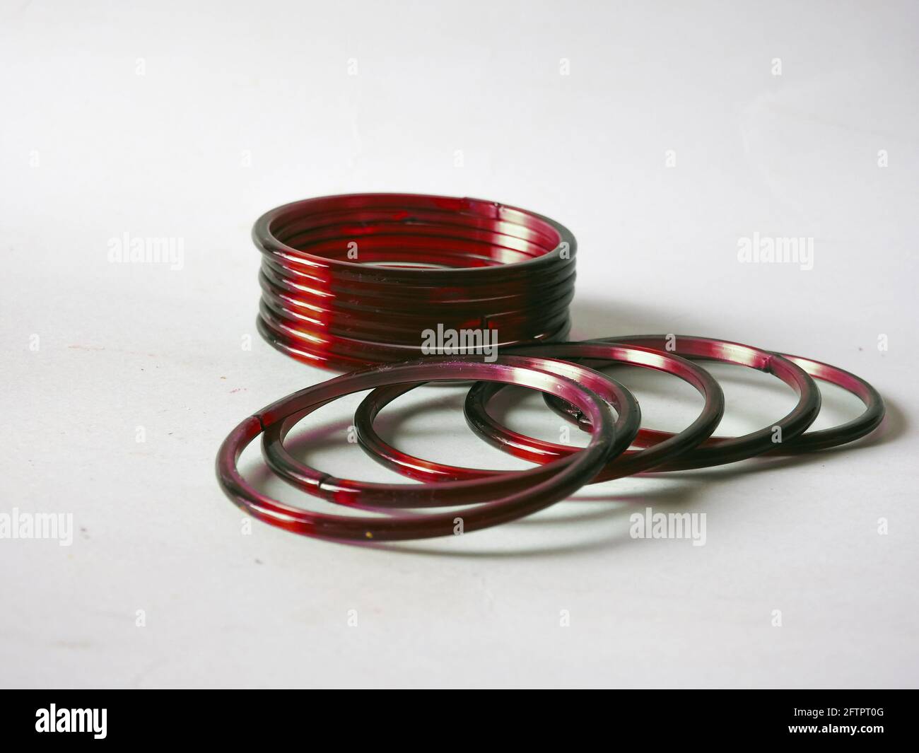 Group of traditional red glass bangles isolated on white background ...