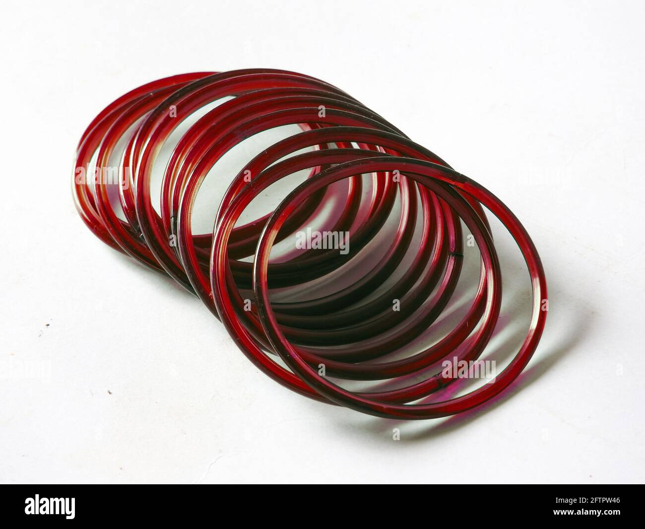 Group of traditional red glass bangles isolated on white background ...