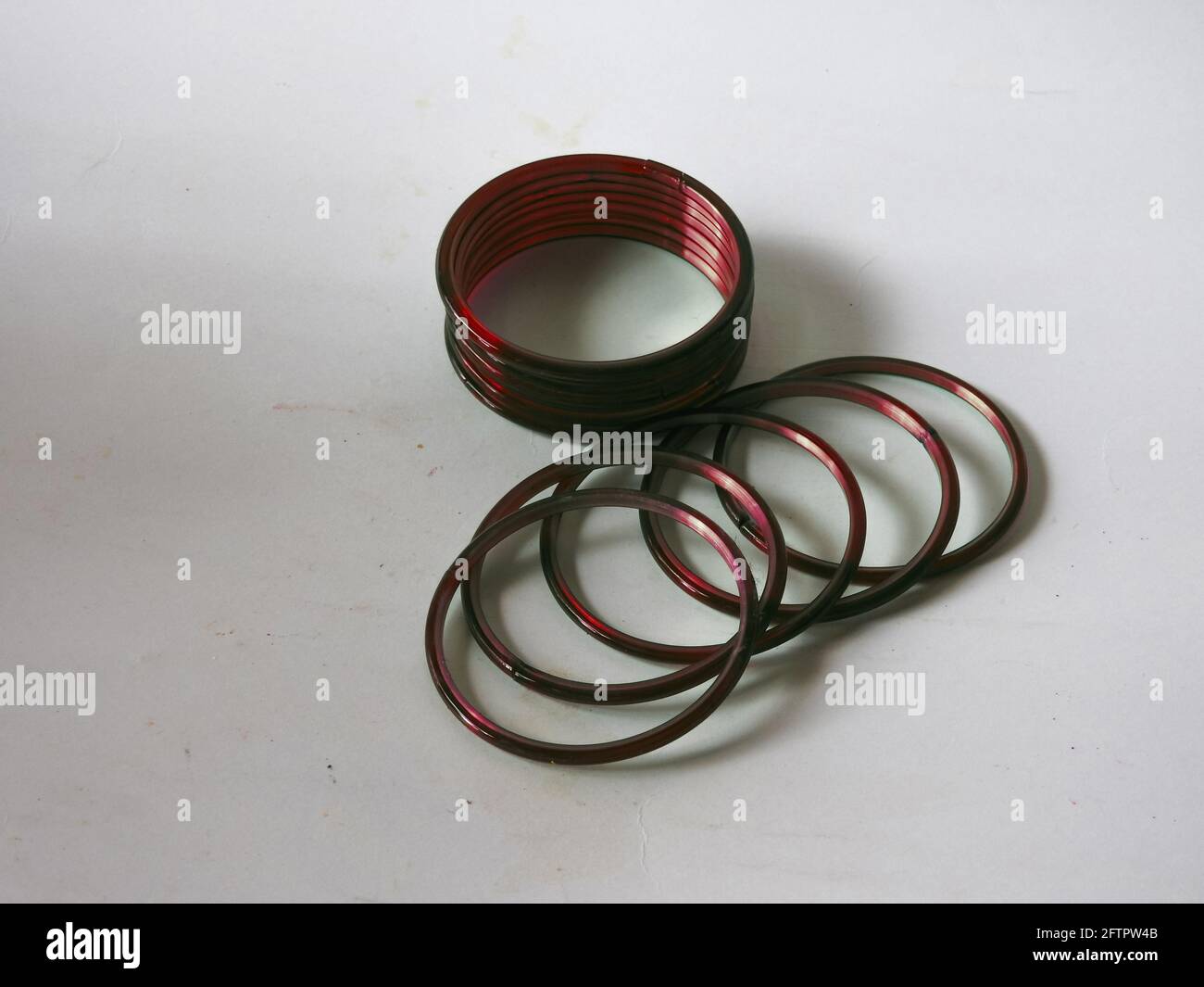 Group of traditional red glass bangles isolated on white background ...