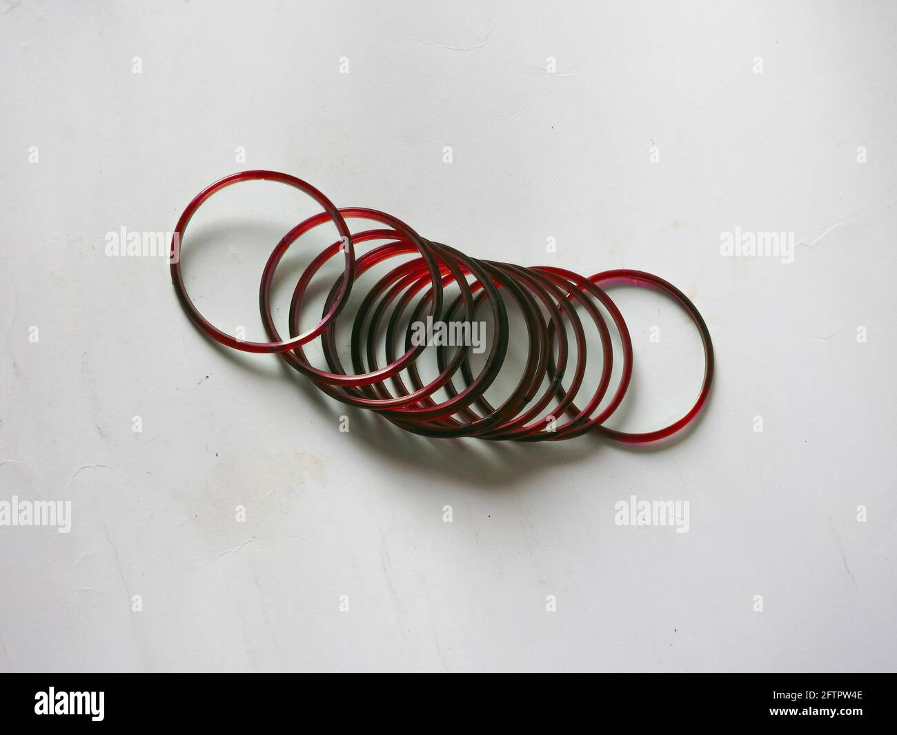 Group of traditional red glass bangles isolated on white background ...