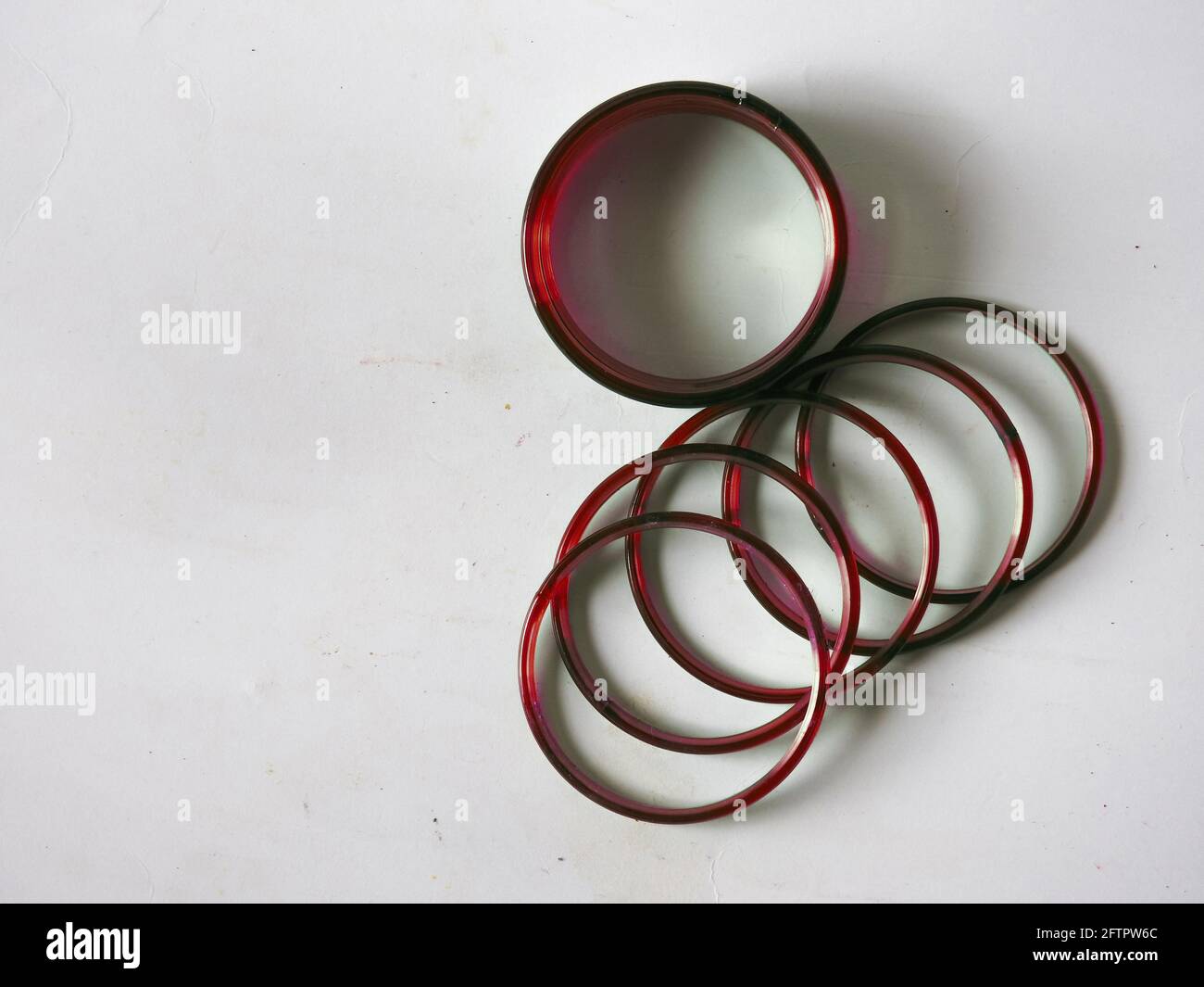 Group of traditional red glass bangles isolated on white background ...