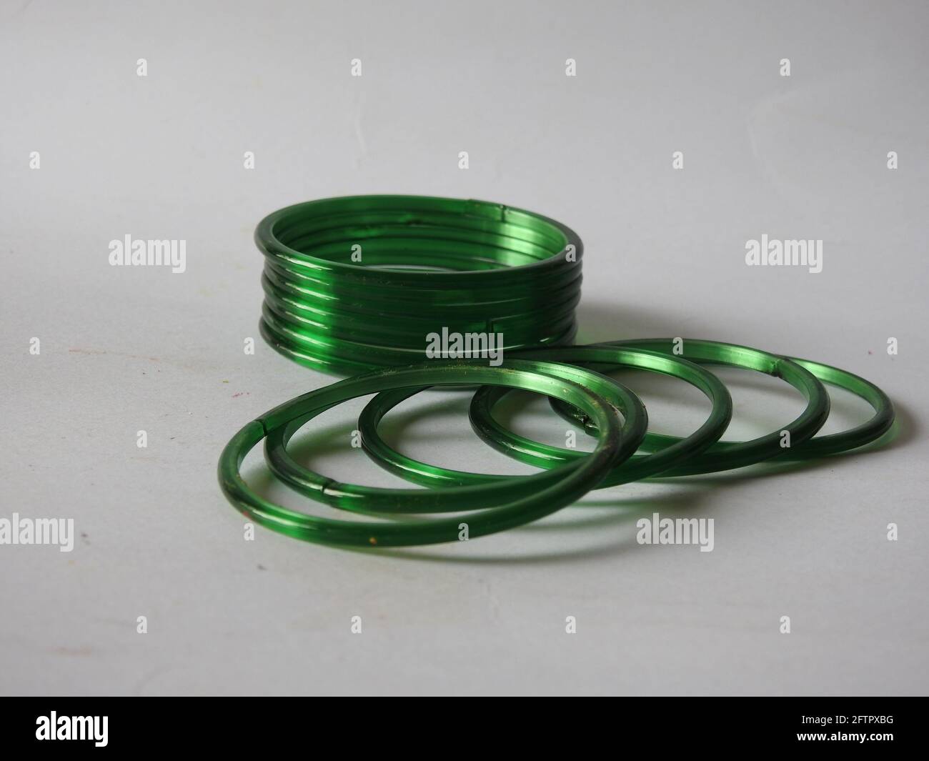 Group of traditional green glass bangles isolated on white background ...