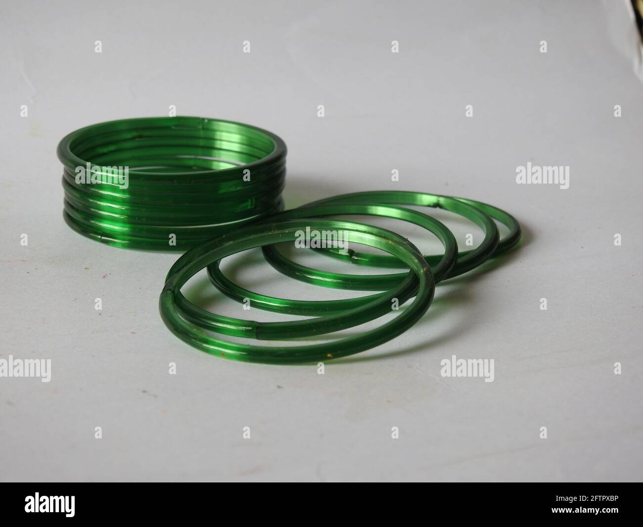 Group of traditional green glass bangles isolated on white background ...
