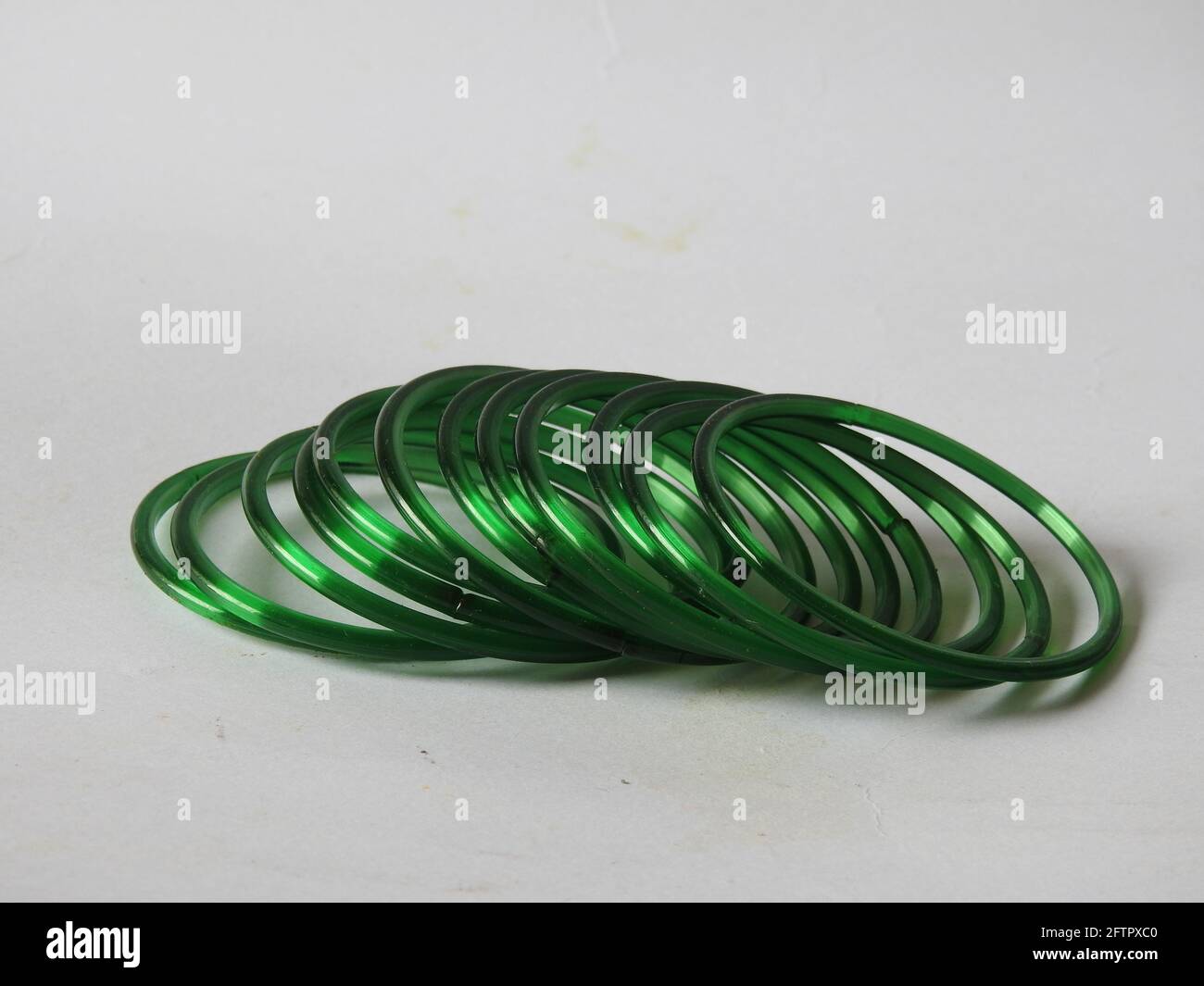 Group of traditional green glass bangles isolated on white background ...