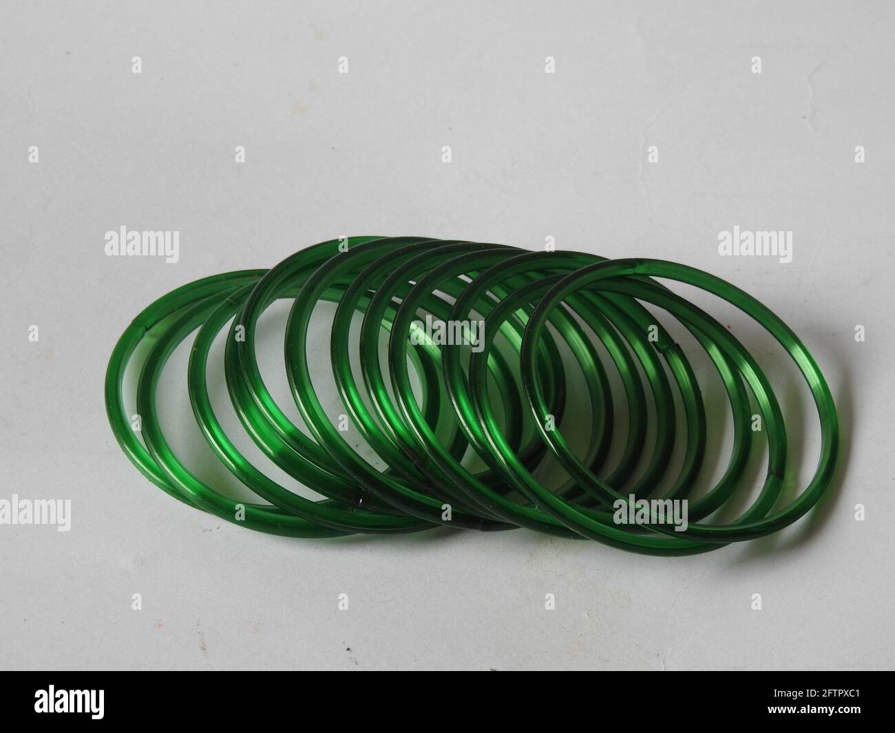 Group of traditional green glass bangles isolated on white background ...