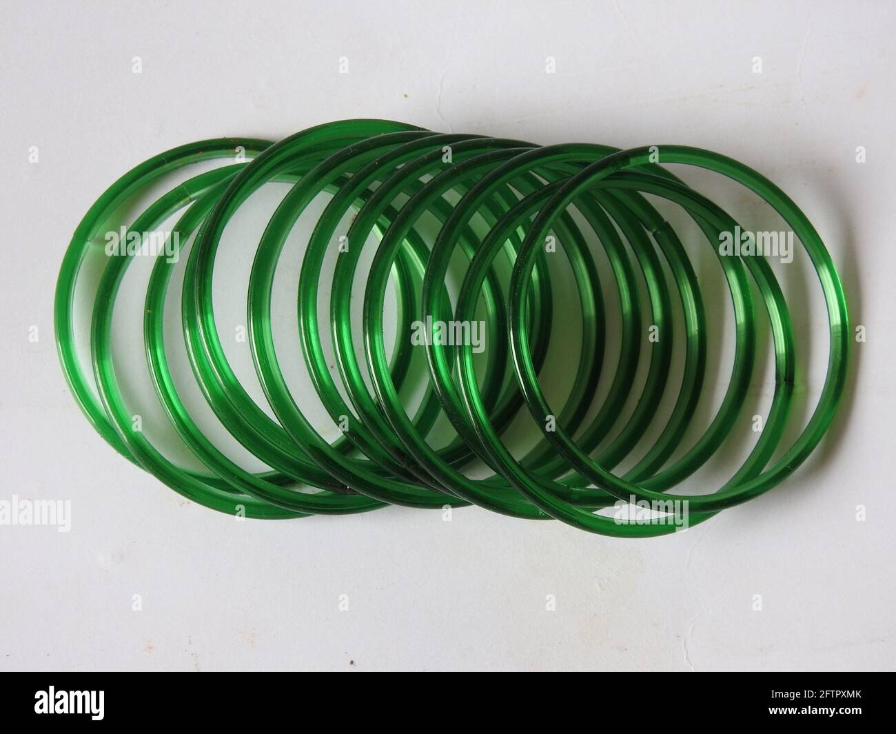 Group of traditional green glass bangles isolated on white background ...