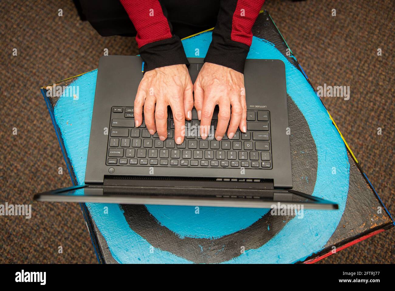 Overhead view of woman's hands typing on a black keyboard laptop Stock ...