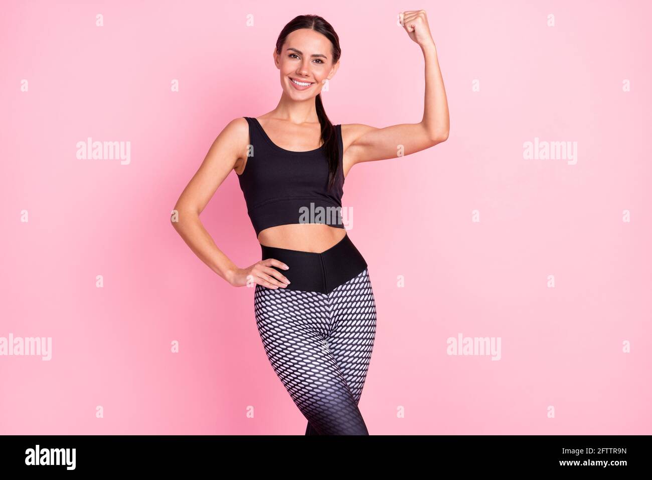 Photo of cute confident young woman dressed sportive arm waist smiling ...