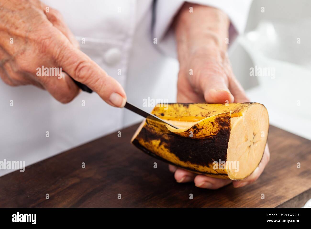 Close up of a senior woman hands while peeling a ripe plantain Stock ...