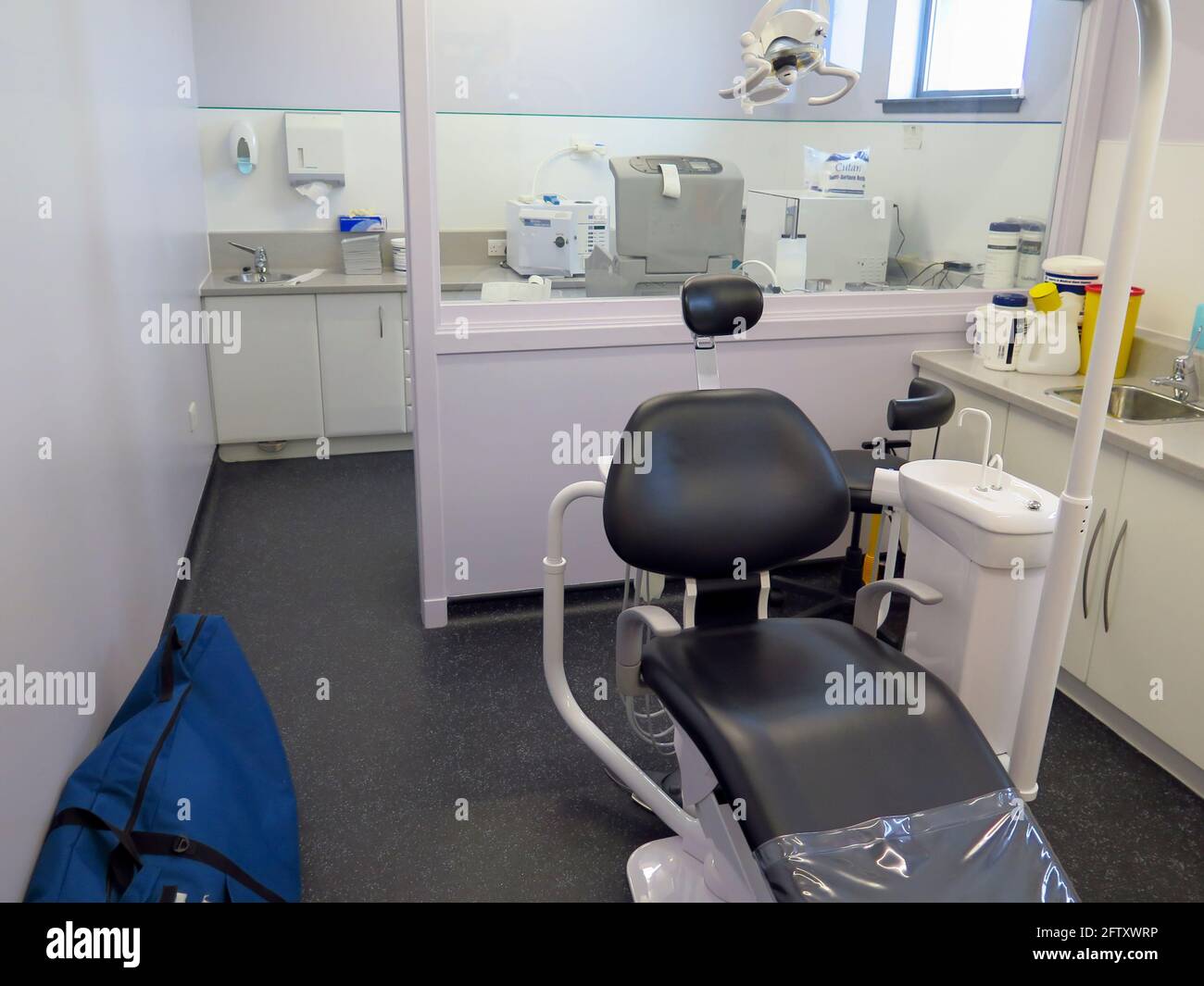Empty dentist surgery with small lab in background Stock Photo - Alamy