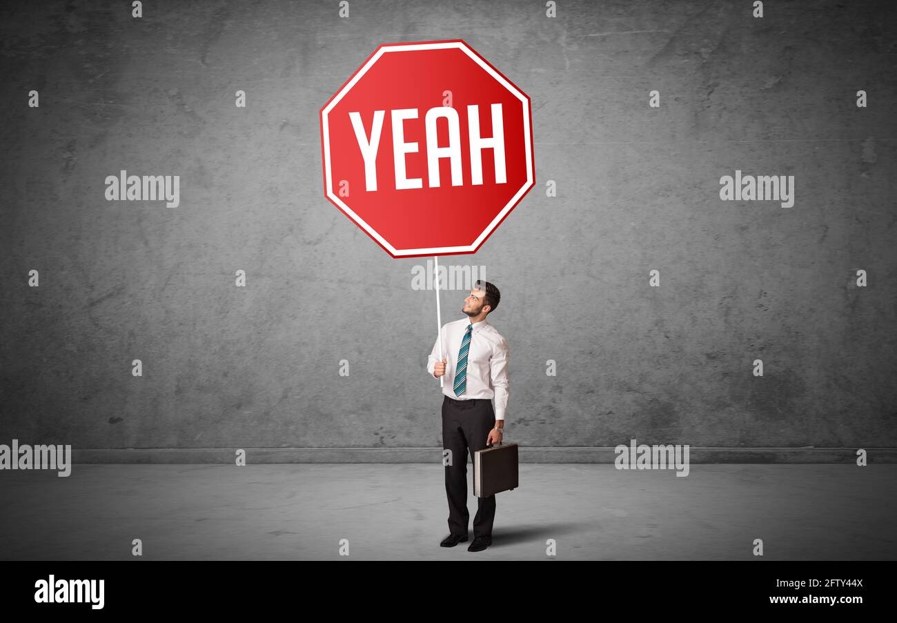 Young business person holding road sign Stock Photo - Alamy