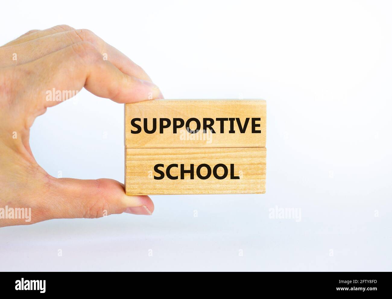 Supportive school symbol. Wooden blocks with words 'Supportive school ...