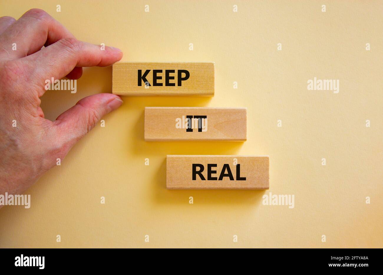 Keep it real symbol. Wooden blocks with words 'keep it real' on ...