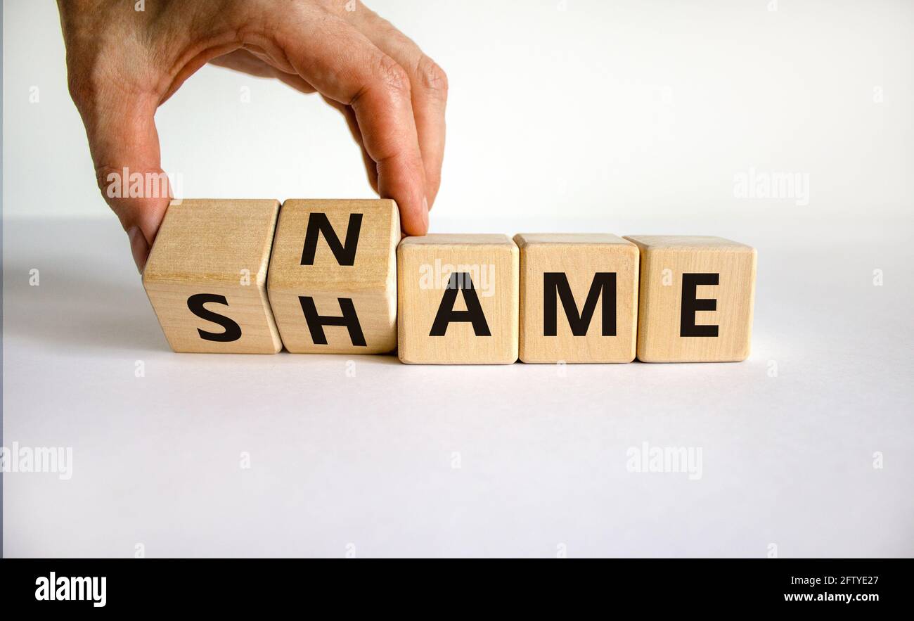 Name or shame symbol. Businessman turns wooden cubes and changes the ...