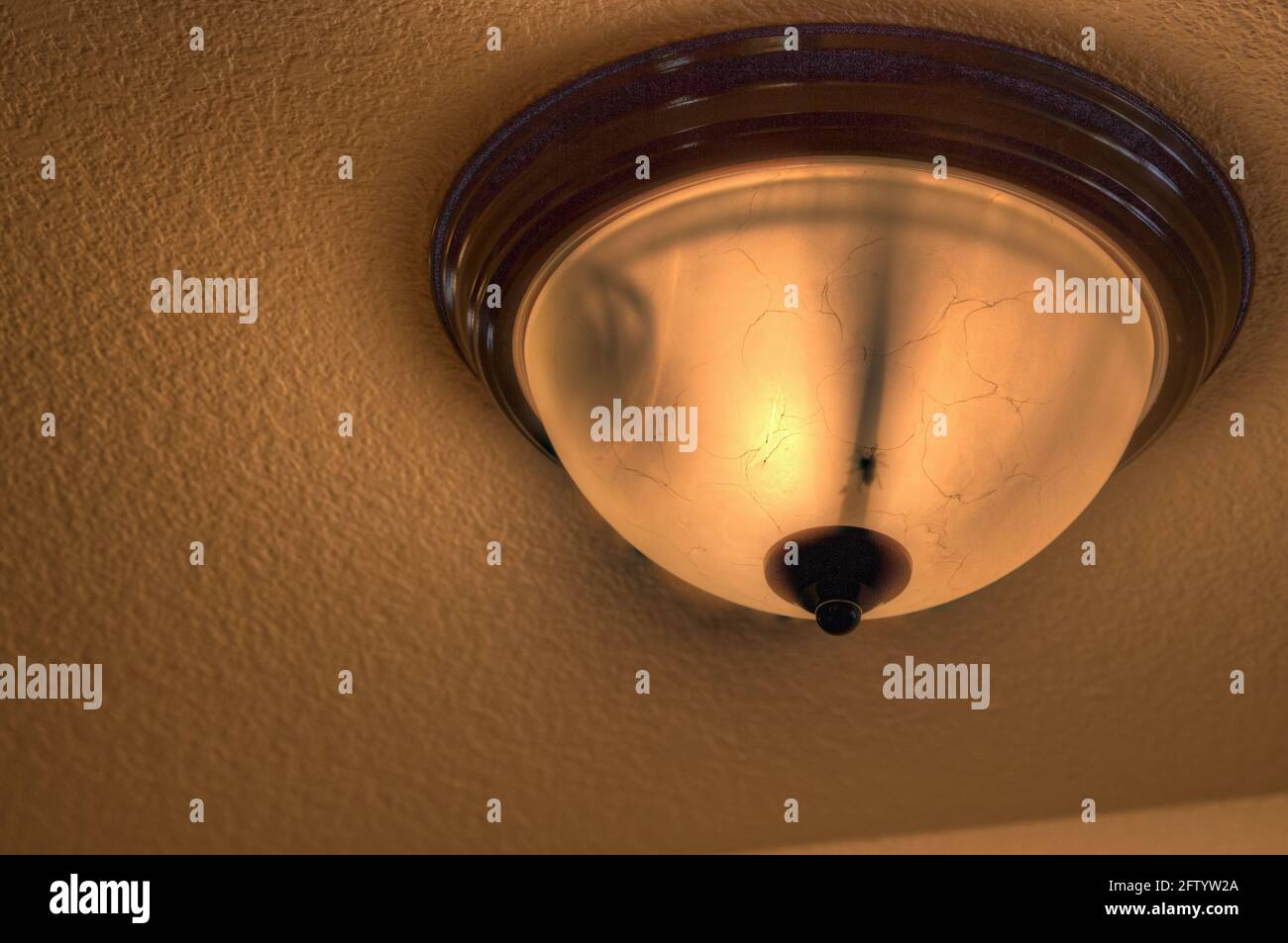 Looking up at an electric ceiling light Stock Photo - Alamy