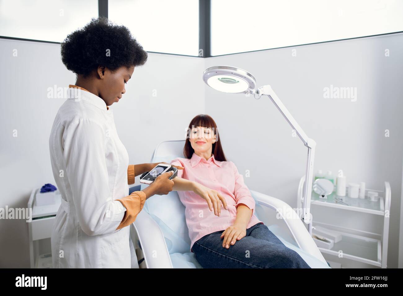 Skin cancer and melanoma prevention. Professional African lady doctor ...