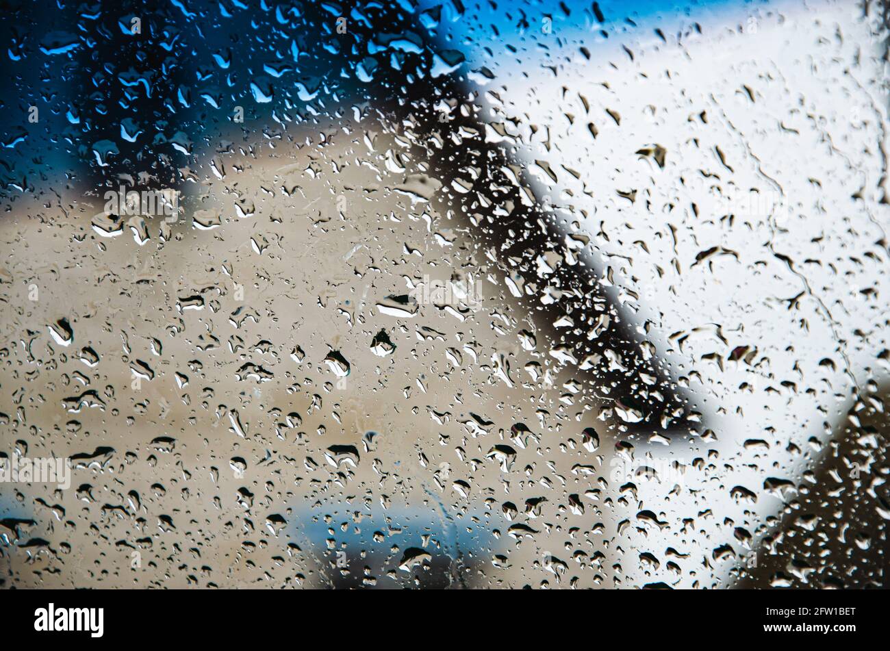 Rain drops on window glasses surface with cloudy background Stock Photo ...