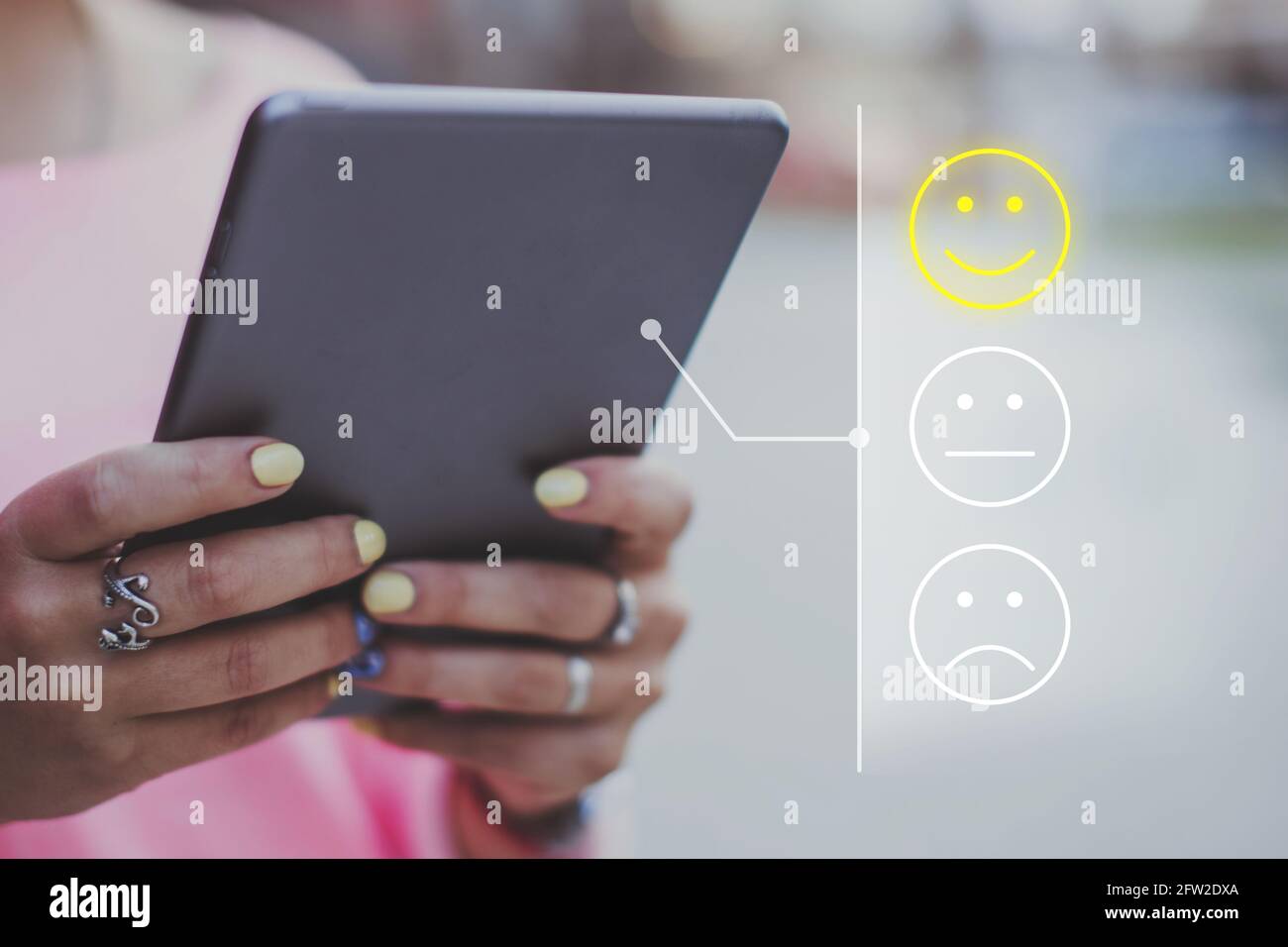 Good mood concept made of emoticon and rating. The girl puts grades on ...